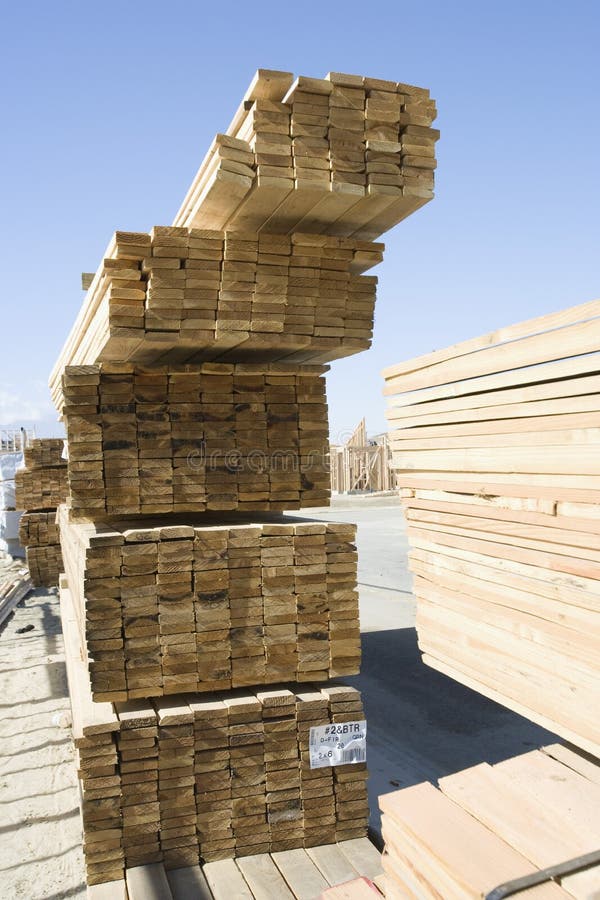 Stacked Lumber and Blueprints at a Construction Si Stock Image - Image ...