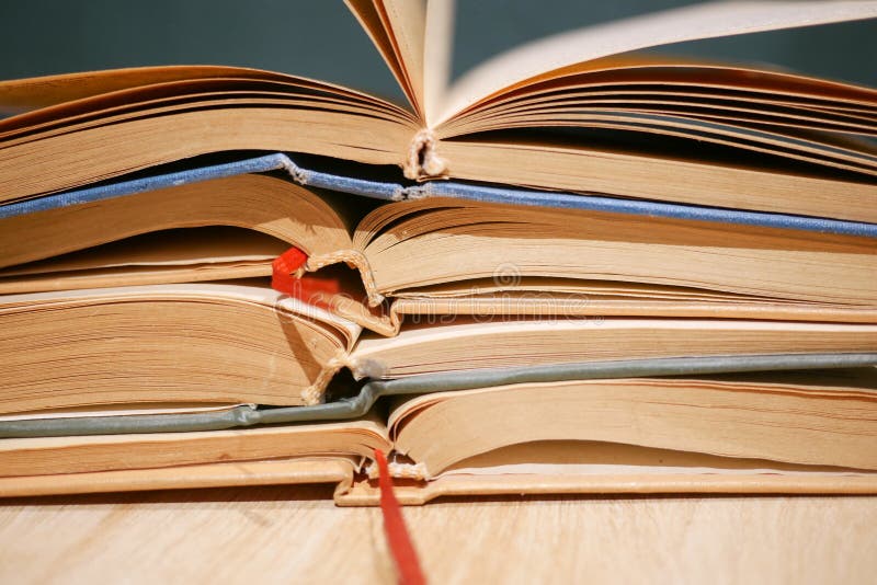 Stacked Open Books with Colorful Bookmarks on a Wooden Table Stock ...