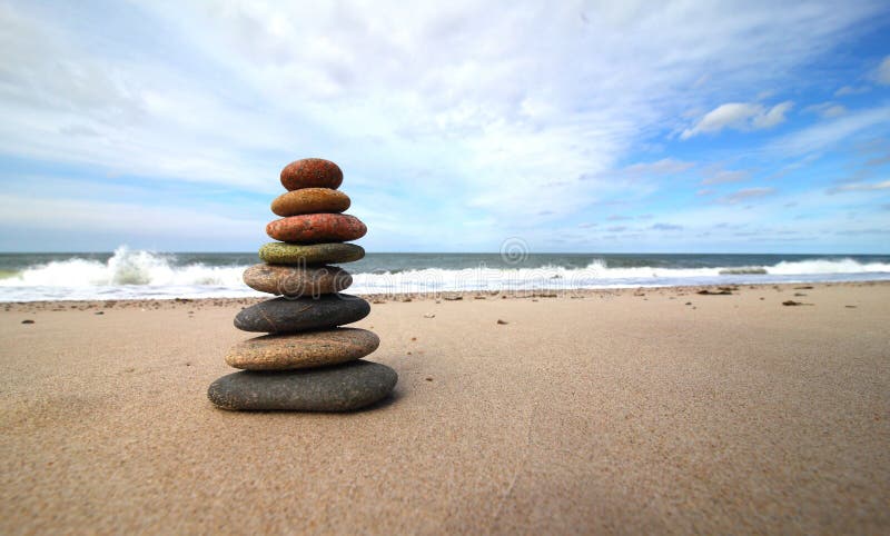 Stacked Pebbles on the Beach Representing Peace with Rock Balancing ...