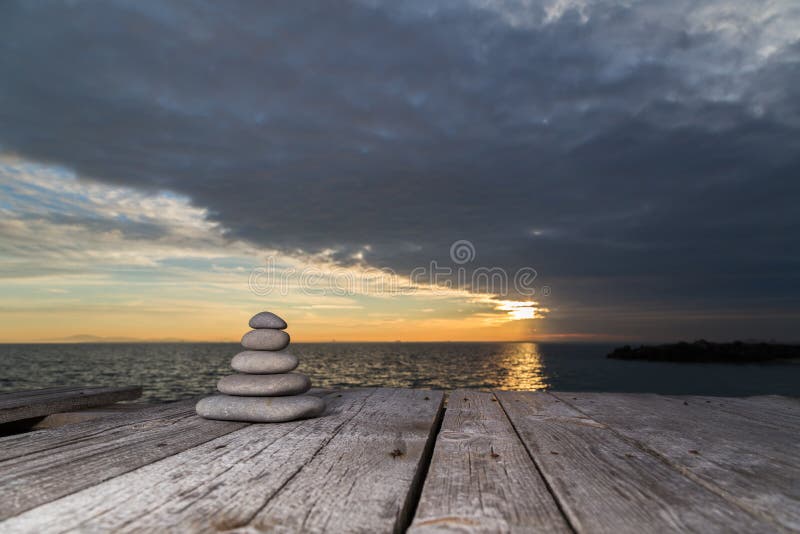 Stacked Pebbles and Setting Sun Stock Photo - Image of landscape, plank ...