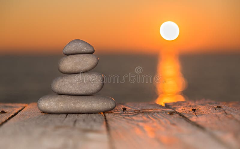 Stacked Pebbles and Setting Sun Stock Image - Image of sunset, surface ...