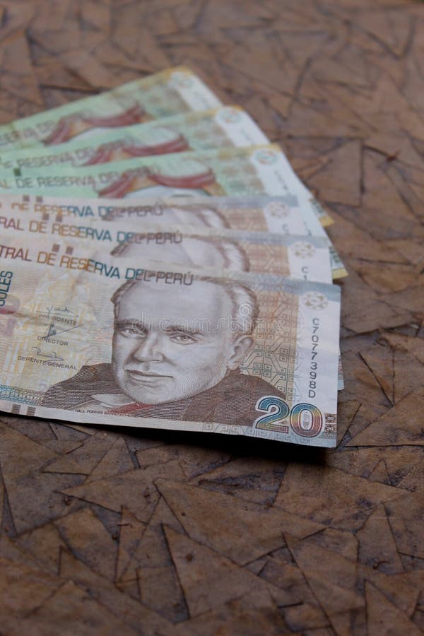 Stacked Peruvian Banknotes of Different Denomination on the Brown ...