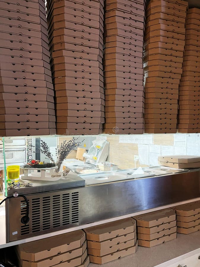 Stacked Pizza Boxes in a Pizzeria Kitchen Showcasing Preparation and ...