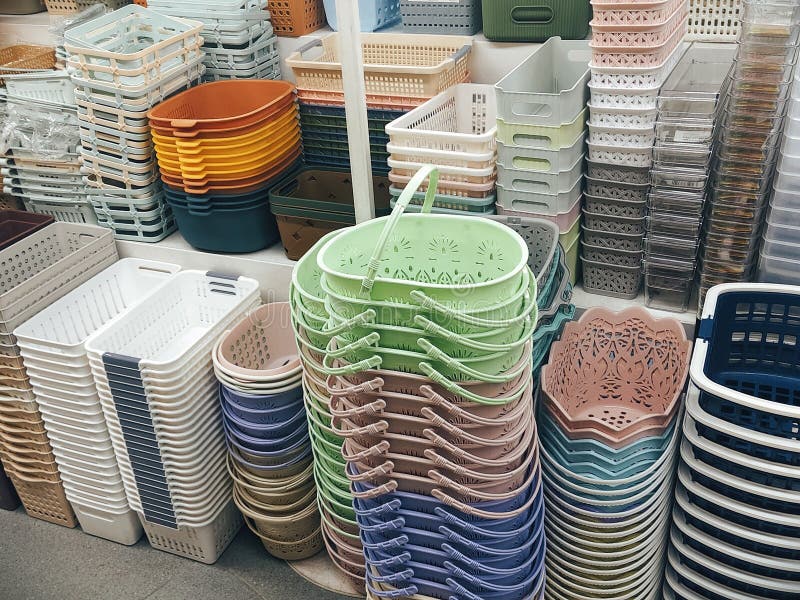 Stacked Plastic Baskets and Containers in Various Colors Displayed in a ...