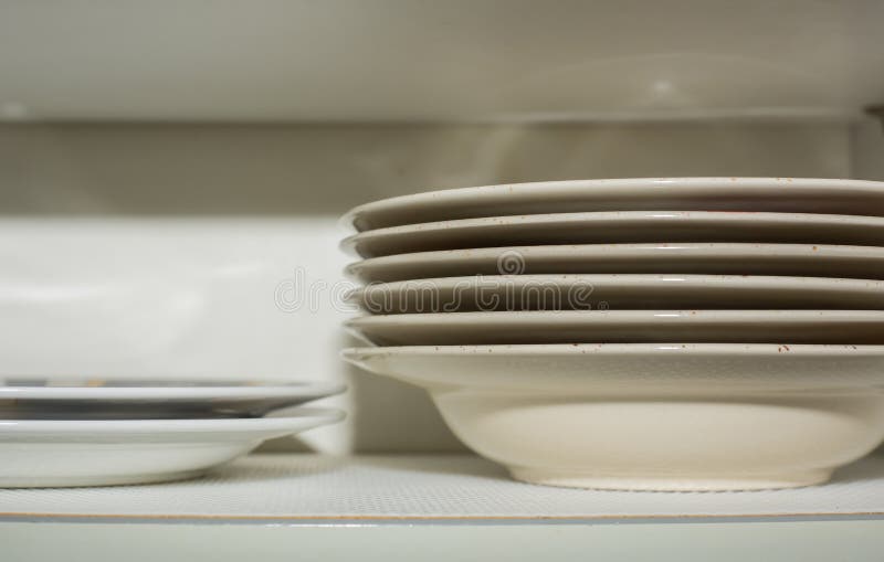 Stacked Plates in the Kitchen Cupboard Stock Image - Image of table ...