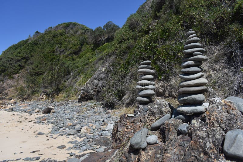 Stacked rocks on the beach stock photo. Image of monument - 111811112