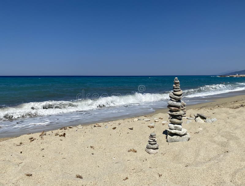 Stacked stones on a beach stock photo. Image of object - 193551944