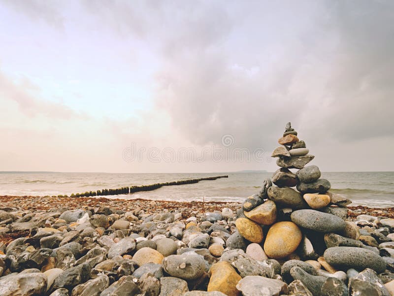 Stacked Rounded Stones at Sea. Polished Pebbles on Dark Wet Rock ...