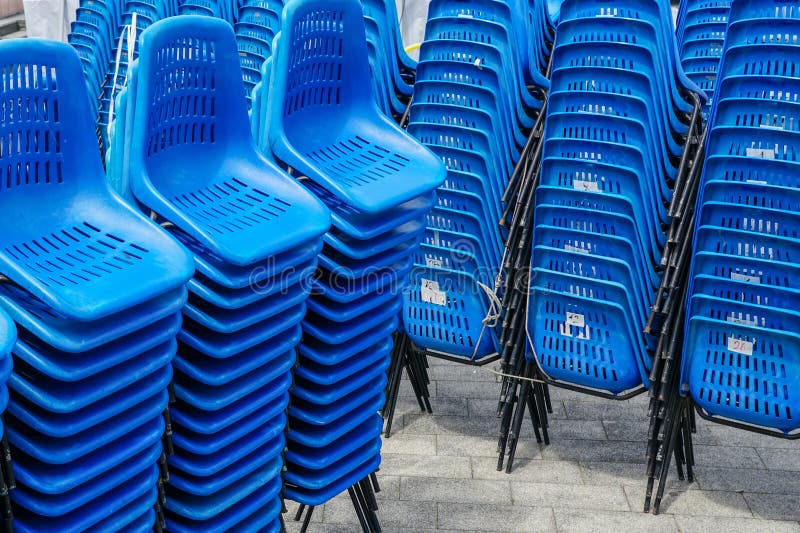 Stacked Rows of Blue Plastic Chairs with Metal Frames for Outdoor ...