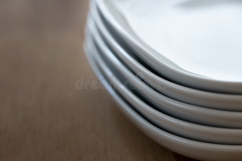 Stacked Square Plates on Wooden Brown Background. Stack Pile of ...