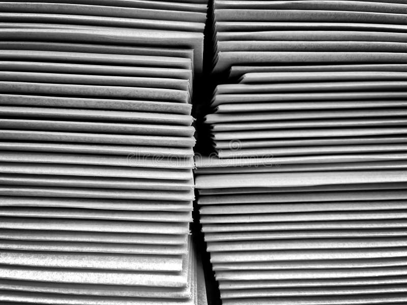 Stacked Stacks of Cardboard are Sitting Next To Each Other in the Dark ...