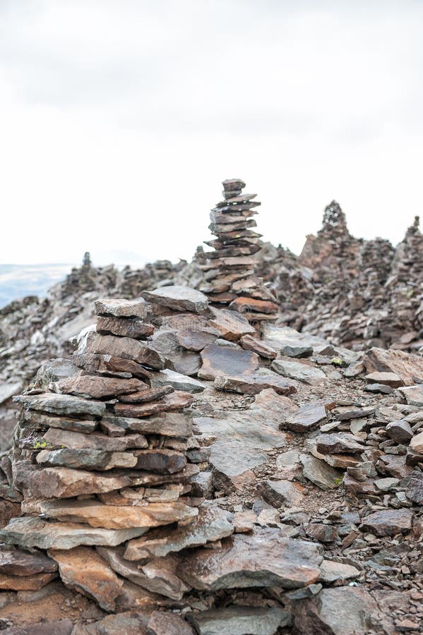Stacked Stone Cairns Under Cloudy Sky Symbolize Tranquility Stock Photo ...