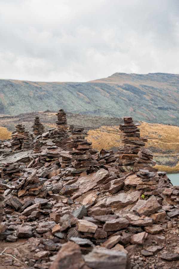 Stacked Stone Cairns Under Cloudy Sky Symbolize Tranquility Stock Photo ...