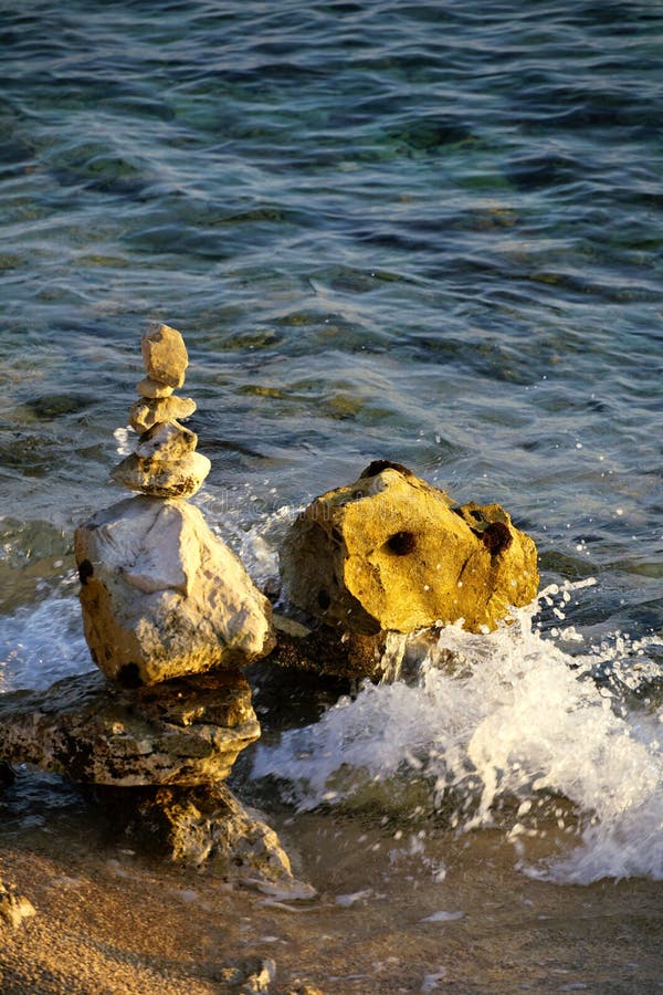 Stacked Stones on the Beach Near the Sea Stock Image - Image of small ...