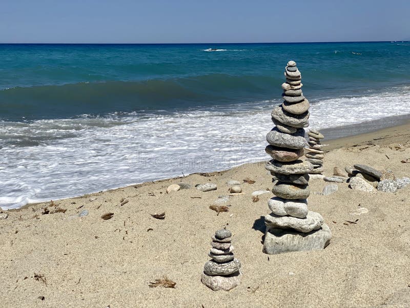 Stacked stones on a beach stock image. Image of greece - 193551955