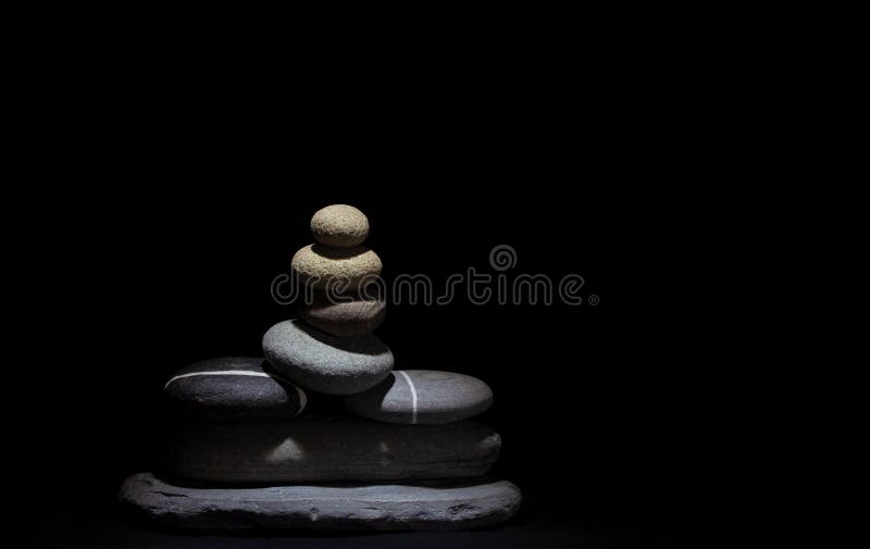 Stacked Stones Under a Soft Light on a Black Background Stock Photo ...