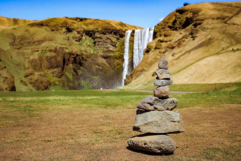 Stacked Stones and the Waterfall in the Background Stock Photo - Image ...