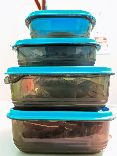A Stacked of Tupperware with Various Size on White Surface Stock Photo ...