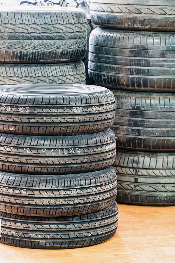Stacked Used Car Tires on Wood Floor Stock Photo - Image of floor ...