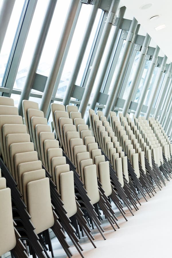 Stacked white chairs stock image. Image of seating, modern - 72837833