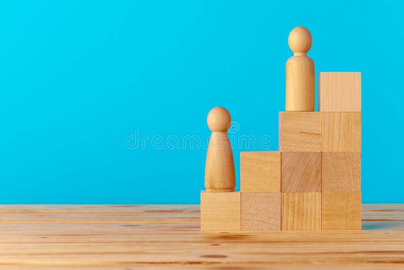 Stacked Wooden Blocks on Wooden Desk Against Blue Background Stock ...