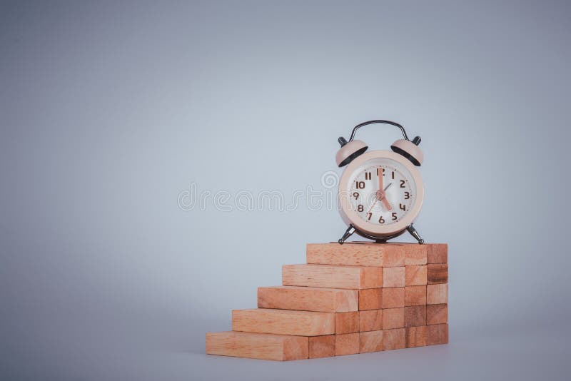 Stacked Wooden Blocks To Develop a Ladder for Clock on Gray Background ...