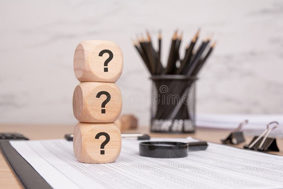 Stacked Wooden Cubes with Question Marks, Symbolizing Uncertainty ...