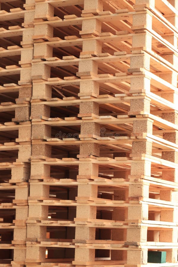 Stacked wooden pallets stock photo. Image of storage - 221607928