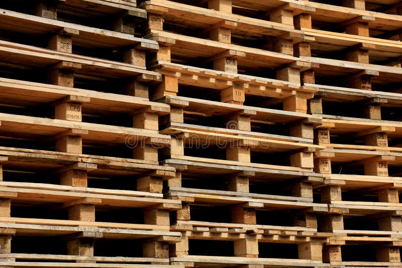 Stacked wooden pallets stock photo. Image of storage - 221607928
