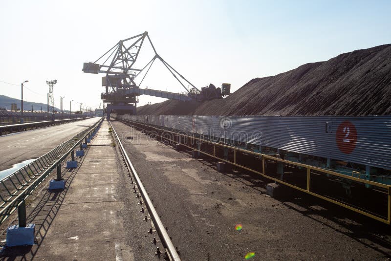 Stacker-reclaimer during Loading and Unloading of Coal. Coal Heaps at a ...