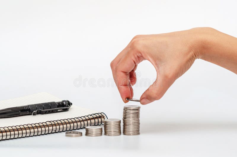Stacking Coins, Notebook with Pen on Table. a Hand Stacks Coins Stock ...