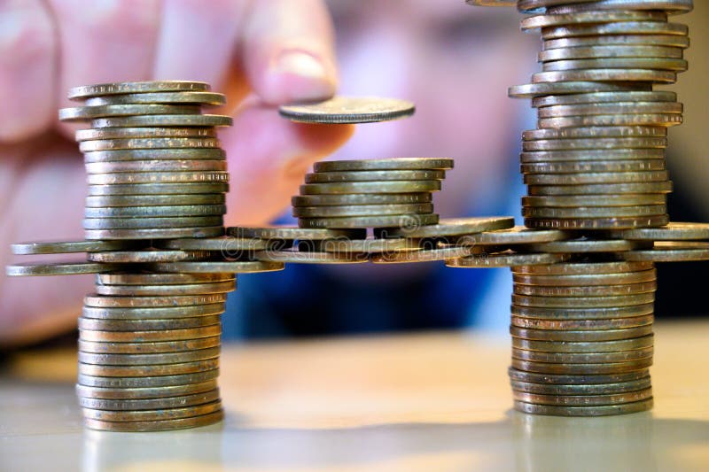 Stacking Gold Dollar Coins into Bridge Using a Cantilever Stock Photo ...