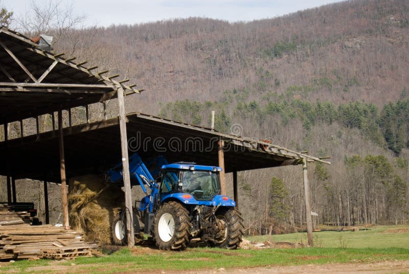 Stacking Hay/Tractor/Barn stock image. Image of blue, bale - 3872975
