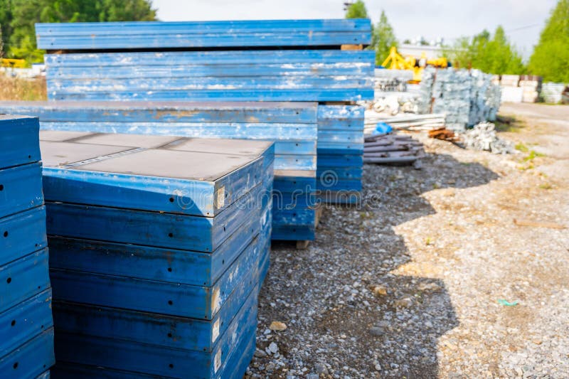 Stacks of Blue Metal Formwork Panels Stored Outdoors at a Construction ...