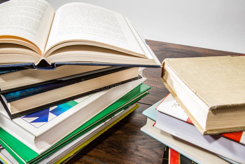 Stacks of Books with One Open on Top of Stack Stock Photo - Image of ...