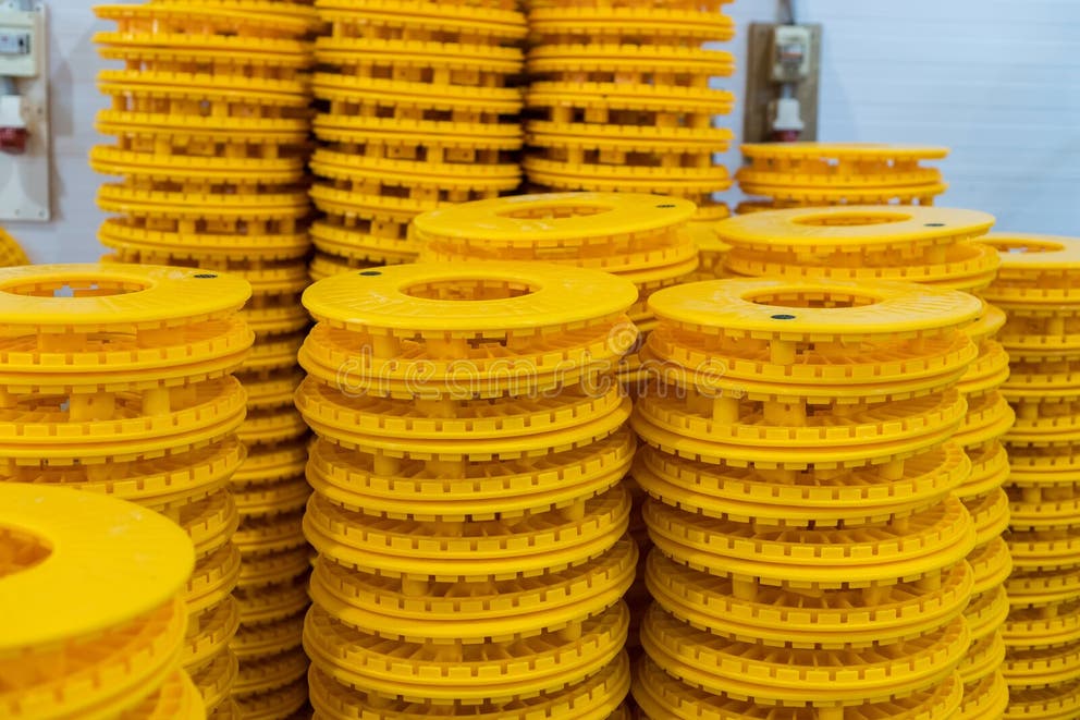 Stacks of Bright Yellow Plastic Cable Reels Forming a Pattern in a ...