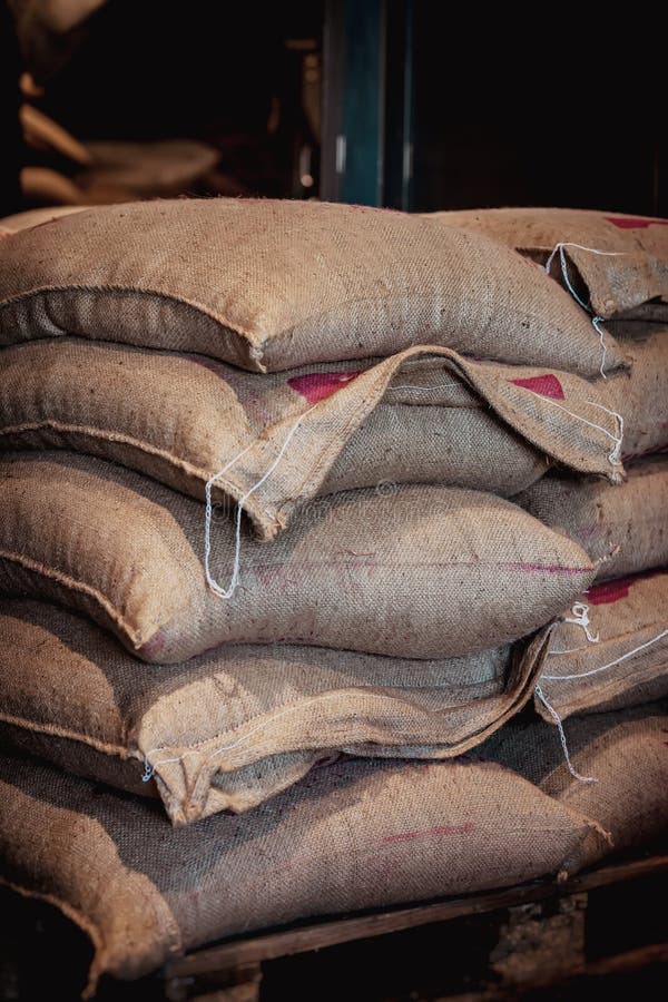 Stacks of Burlap Sacks Full of Coffee Beans are Stored in Warehouse ...