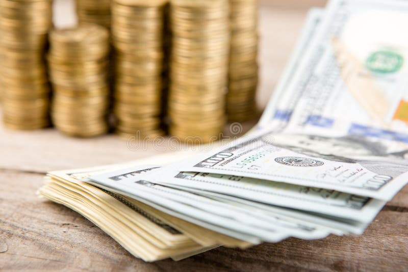 Stacks of Coins and Dollar Bill on Wooden Background Stock Photo ...