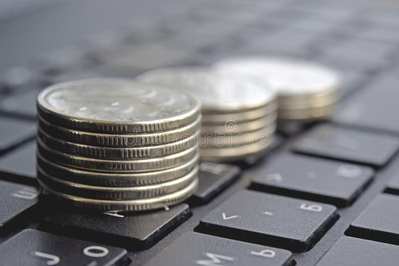 Stacks of Coins on Laptop Keyboard Stock Photo - Image of coins, change ...