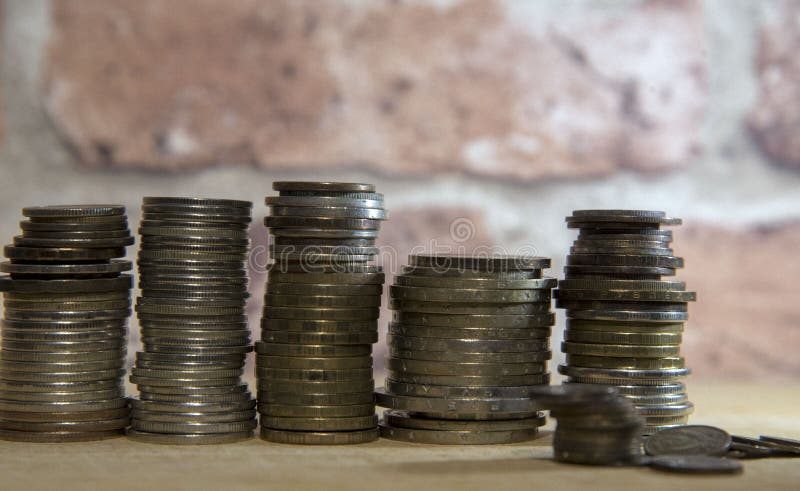 Stacks of Coins and a Vintage Brick Wall Stock Image - Image of growth ...