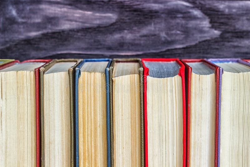 Stacks of Colored Books on a Wooden Table. Concept of Reading Habits ...