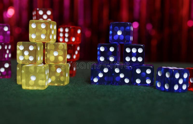 Stacks of Colorful Dice on Green Felt with Bokeh Background Stock Image ...