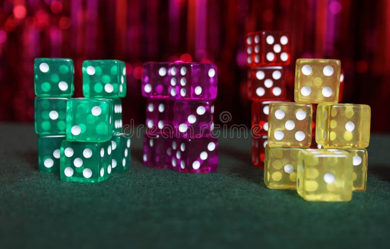 Stacks of Colorful Dice on Green Felt with Bokeh Background Stock Image ...