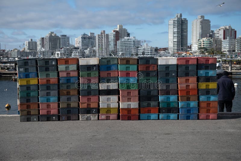 Stacks of Colorful Plastic Crates in Front of a Cityscape at a ...