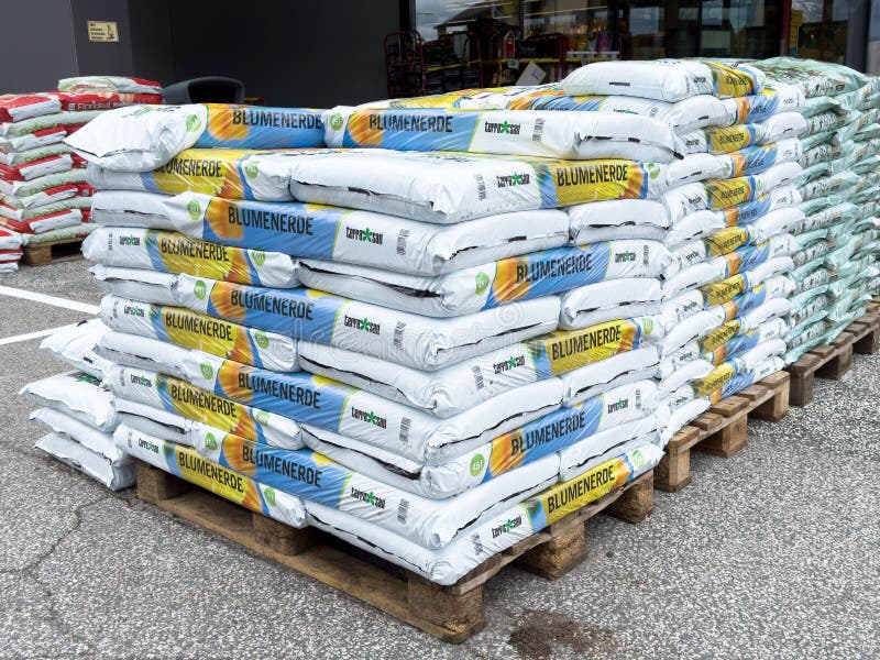 Stacks of Compost Soil Bags Displayed on Wooden Pallets Outside ...