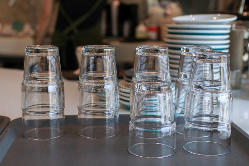 Stacks of Empty Glasses on Bar Counter in Cafe. Piles of Upside Down ...