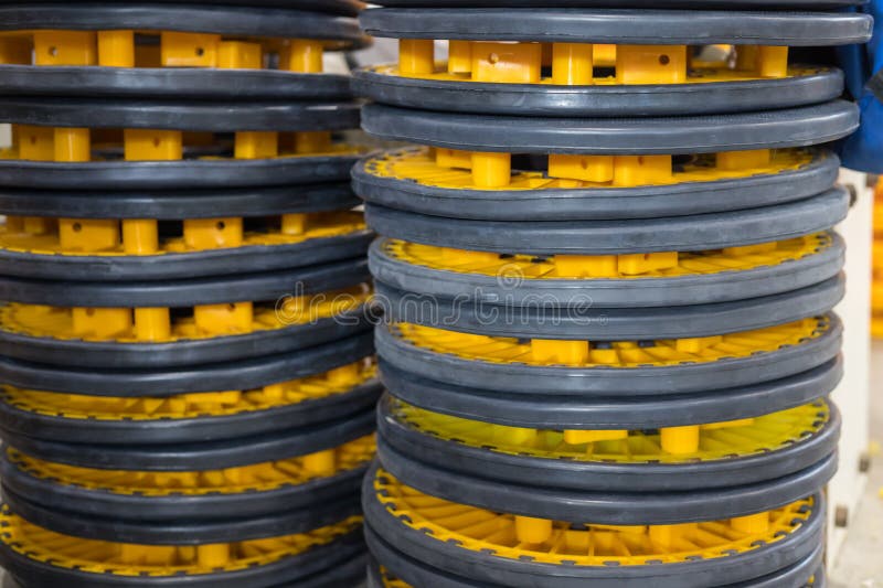 Stacks of Industrial Wheels with Yellow Hubs Forming a Column Stock ...