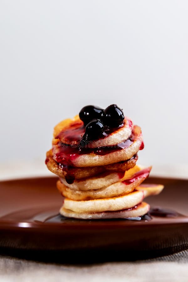Stacks of Mini Pancakes on a Saucer with Blackcurrant Syrup. Stock ...