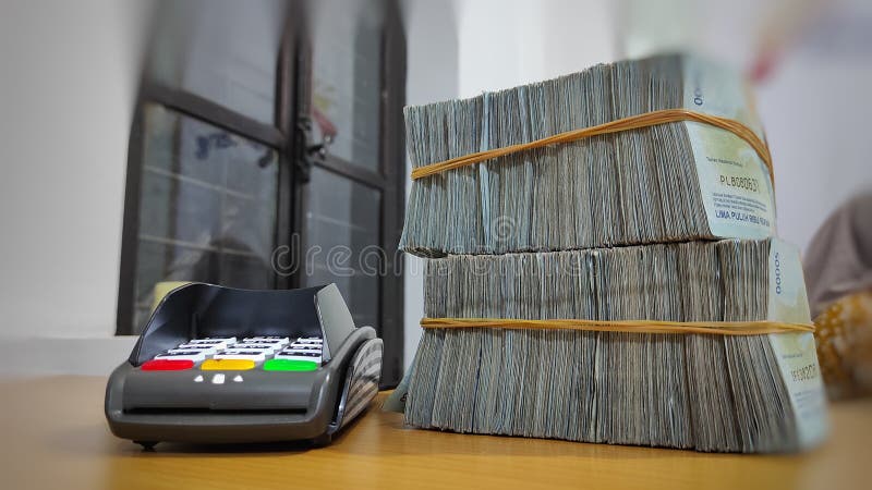 Stacks of Money and Transactions Using Edc (Electronic Data Capture ...