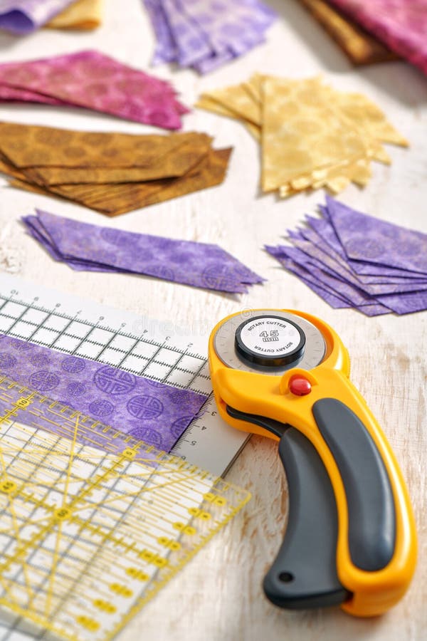 Stacks of Multi-colored Pieces of Fabric, Cutting Mat, Ruler, Rotary ...